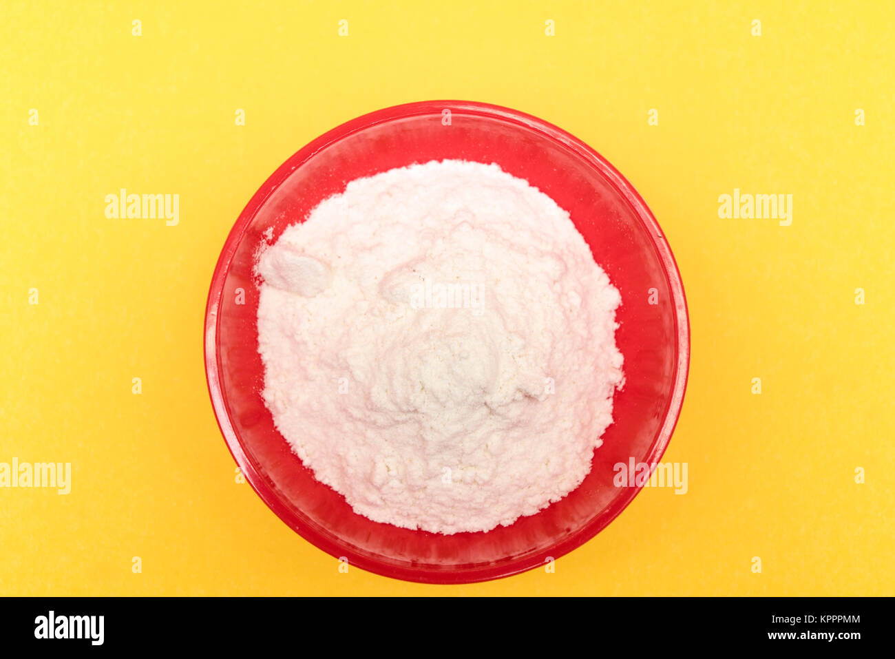 flour in a bowl on a colored background Stock Photo - Alamy
