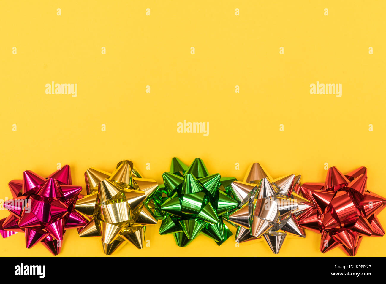 row of colored bows on a colored background Stock Photo - Alamy