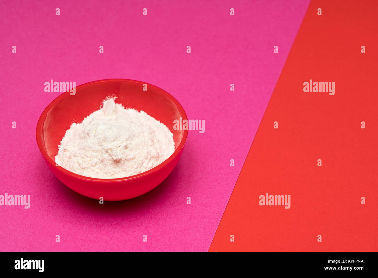 flour in a bowl on a colored background Stock Photo - Alamy