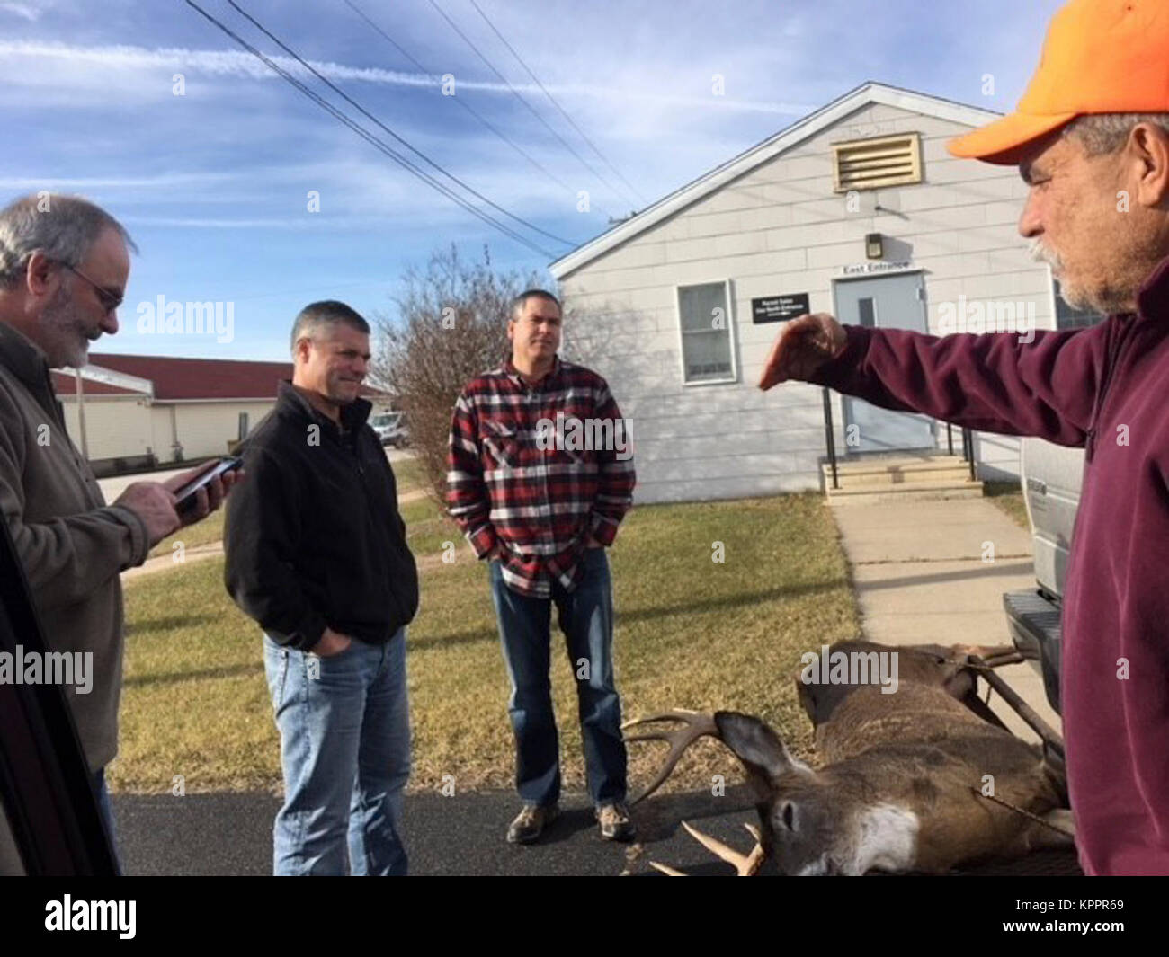 Hunter Pete Hodges (right) explains how he harvested this large deer ...