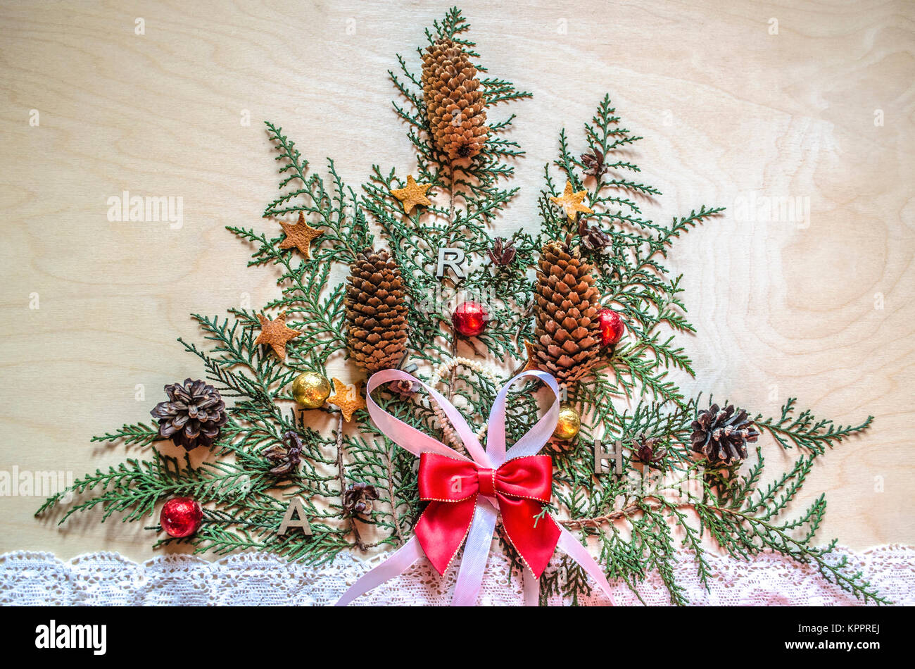 Light plywood with a Christmas tree, made of twigs thuja with fir cones ...
