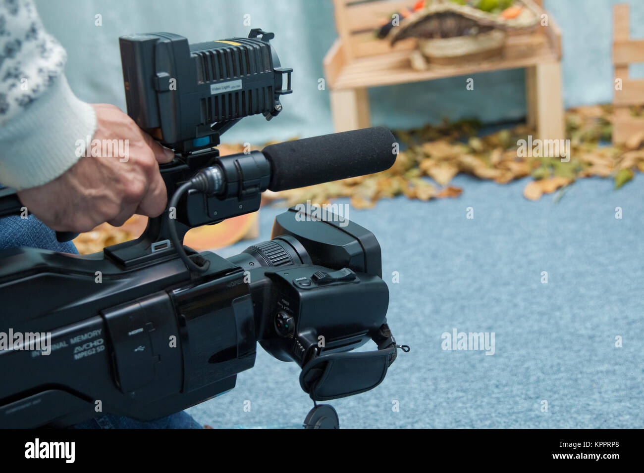 Video camera operator working with his equipment Stock Photo - Alamy