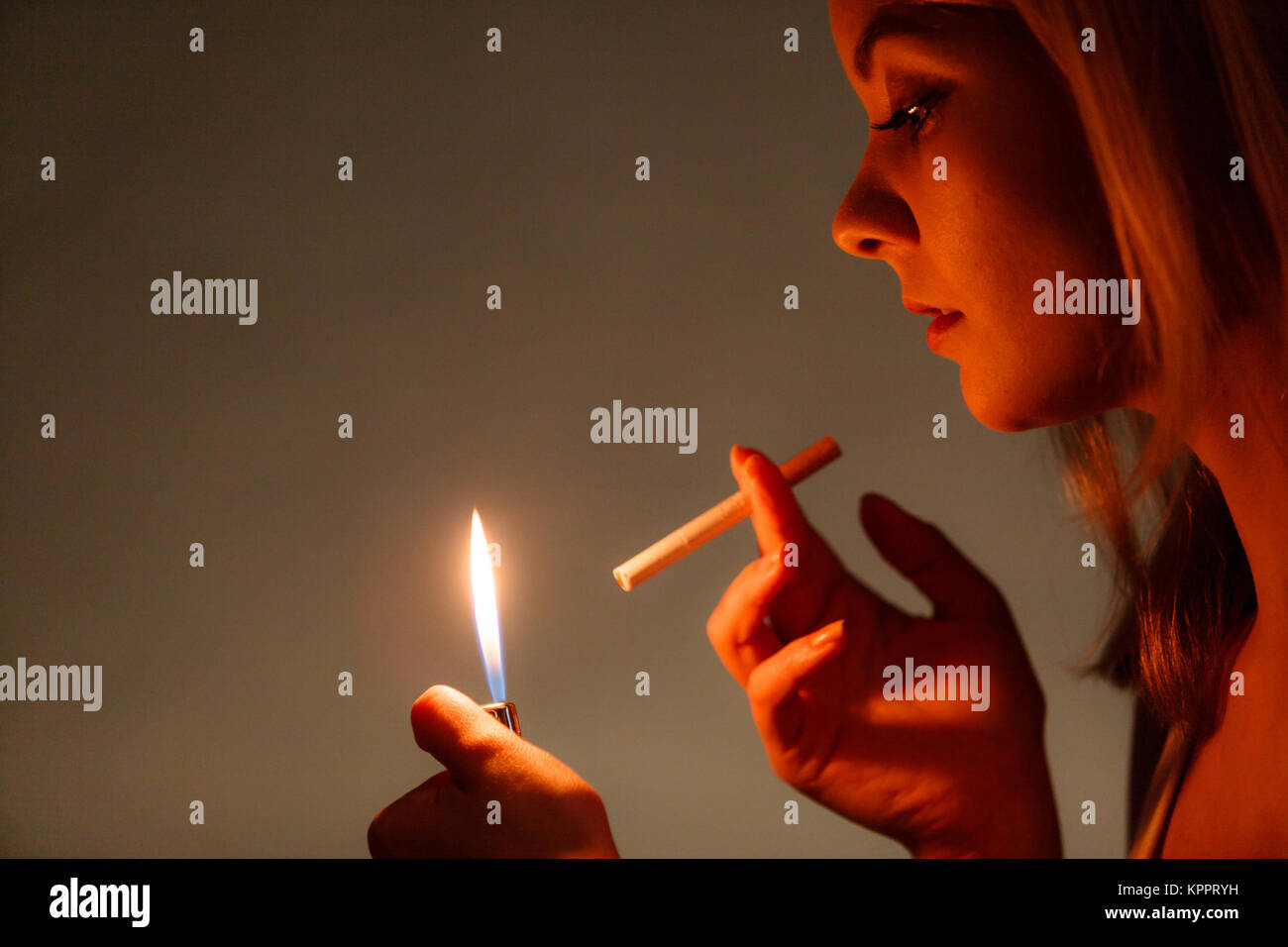 Pretty girl smoking cigarette using lighter. Addicted nicotine problems ...