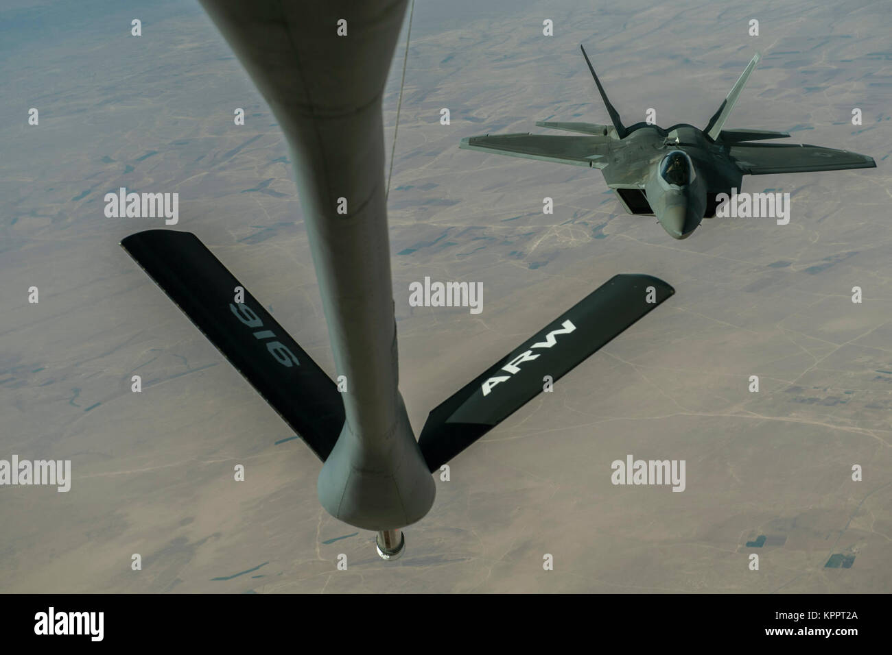 A U.S. Air Force F-22 Raptor receives fuel from a KC-135 Stratotanker ...