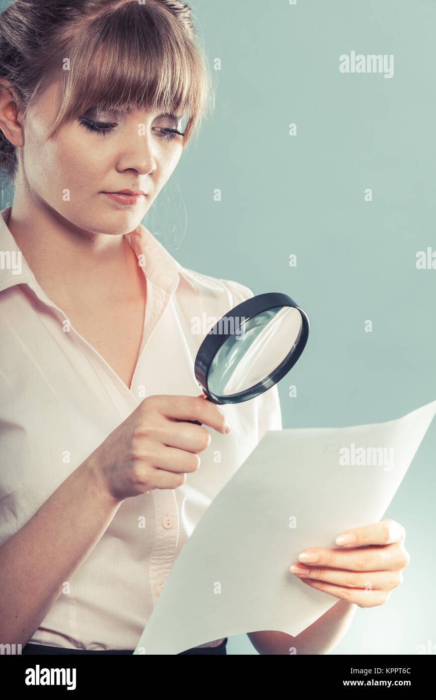 Business woman using magnifying glass to check contract instagram ...