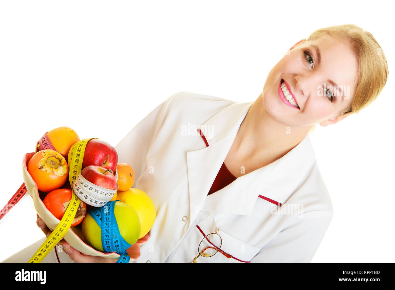 Woman in white lab coat holding fruits and colorful measure tapes ...