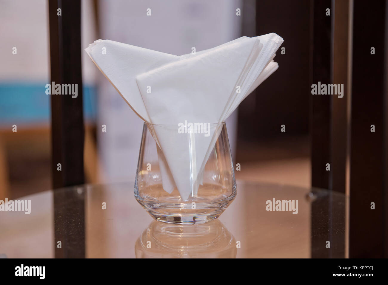 Napkin orderly manner fold in glass setting on dining table for dinner ...