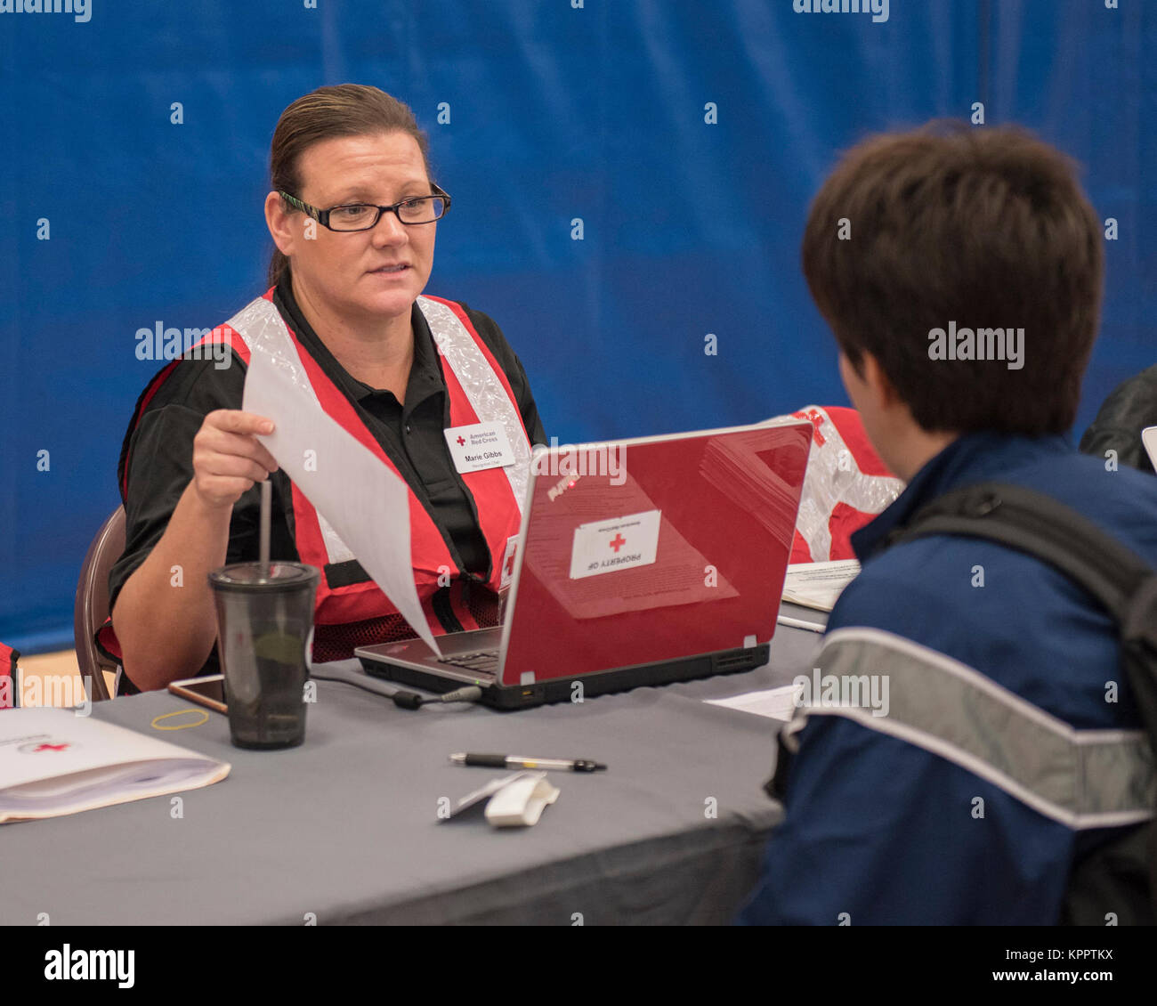 Marie Gibbs, American Red Cross disaster action team volunteer, assists ...