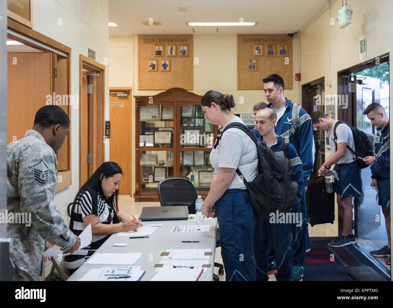 A line of simulated non-combatants awaits processing through a ...