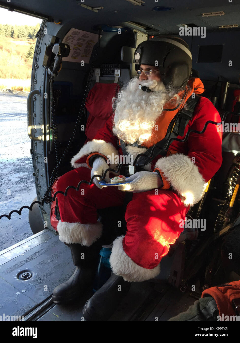 Santa Claus waits in a Coast Guard Air Station Kodiak MH-60 Jayhawk ...