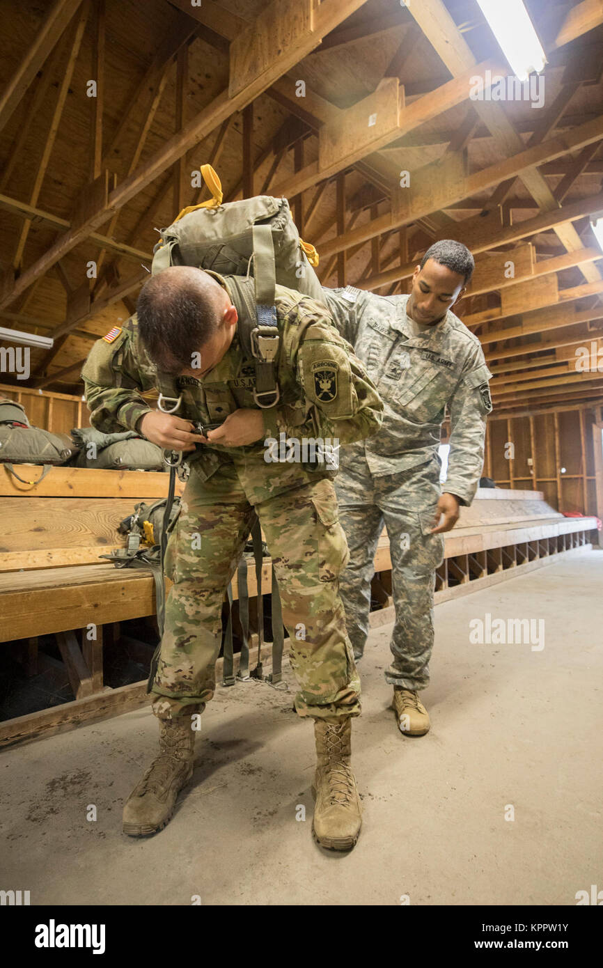 U.S. Army paratroopers don parachute during the 20th Annual Randy Oler ...
