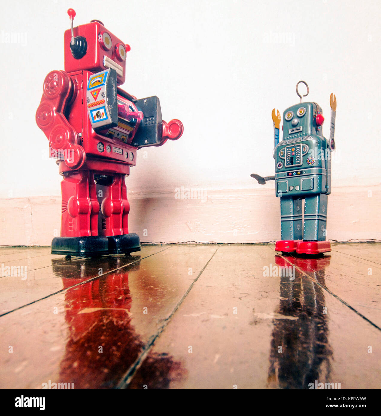 stick them up , robo cop puts robot undr arrest , on old wooden floor ...