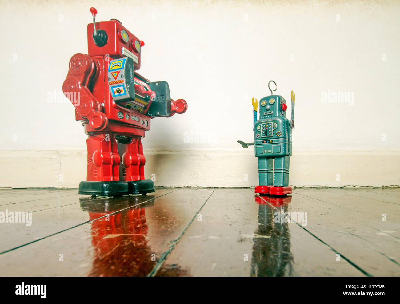 stick them up , robo cop puts robot undr arrest , on old wooden floor ...