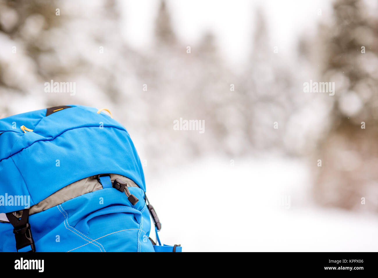 Backpack in the snowy forest Stock Photo - Alamy