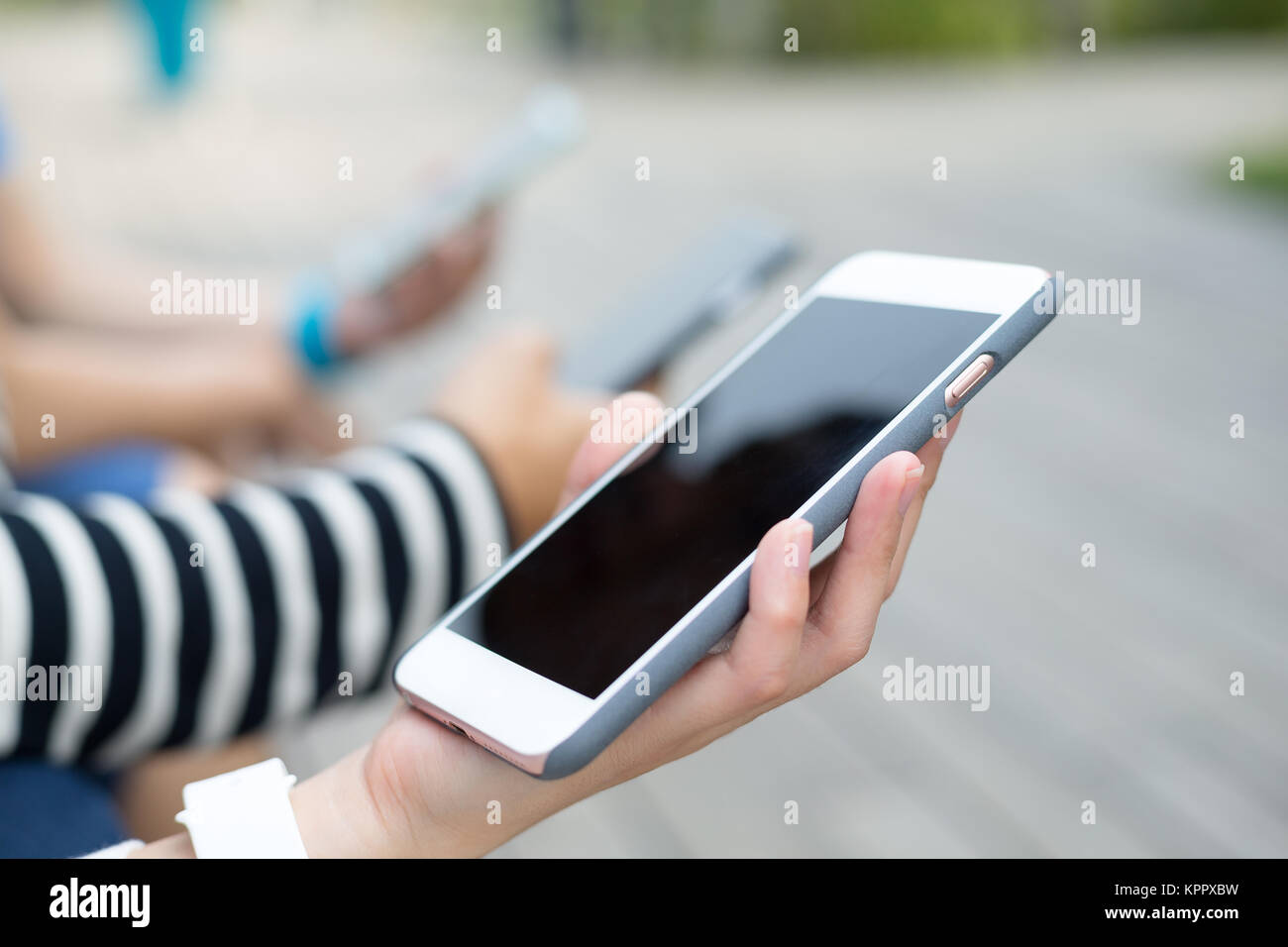 Group of people using cellphone together Stock Photo - Alamy