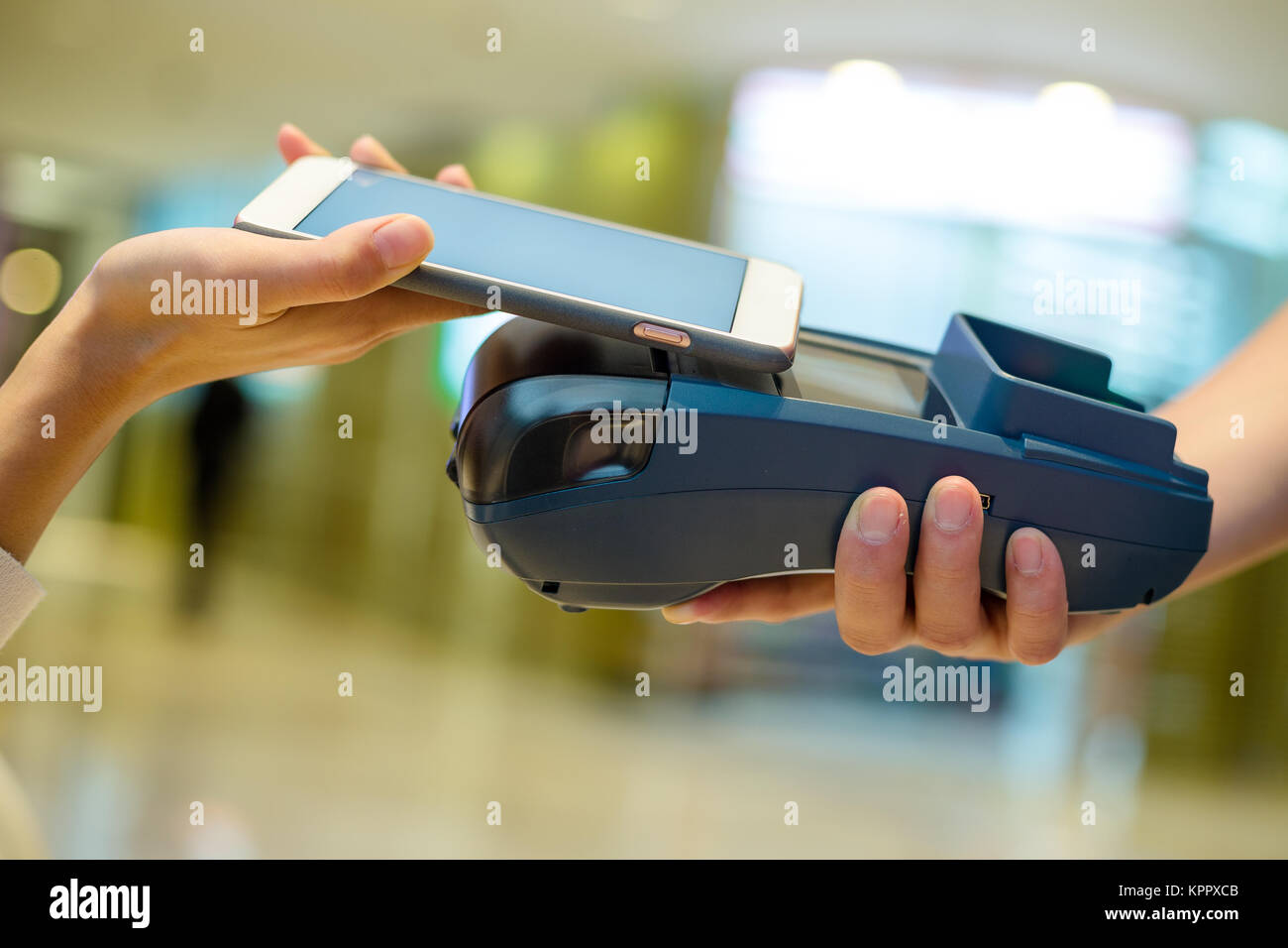 Customer using cellphone for payment Stock Photo - Alamy