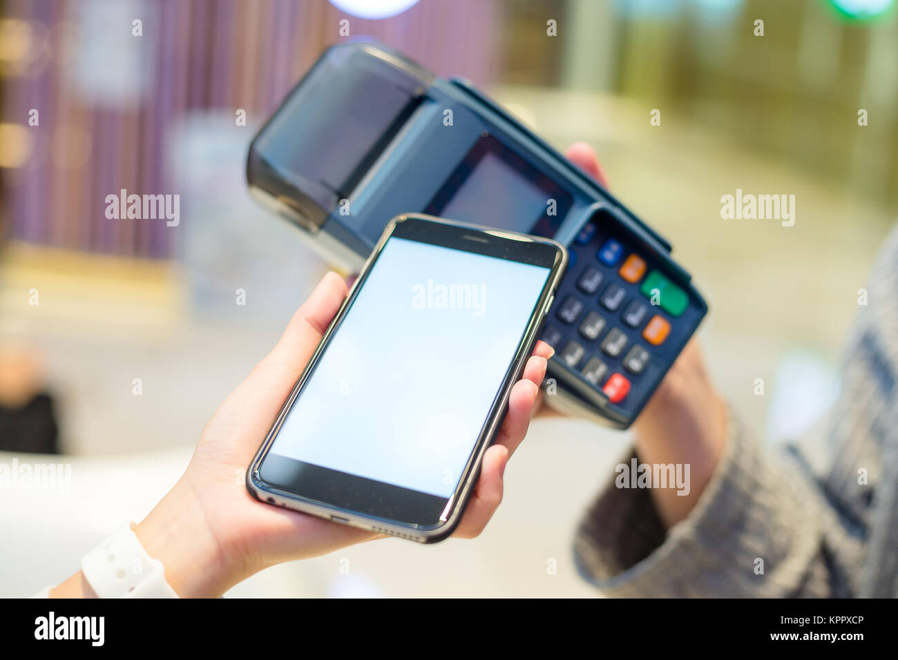 Woman using cellphone to checkout Stock Photo - Alamy
