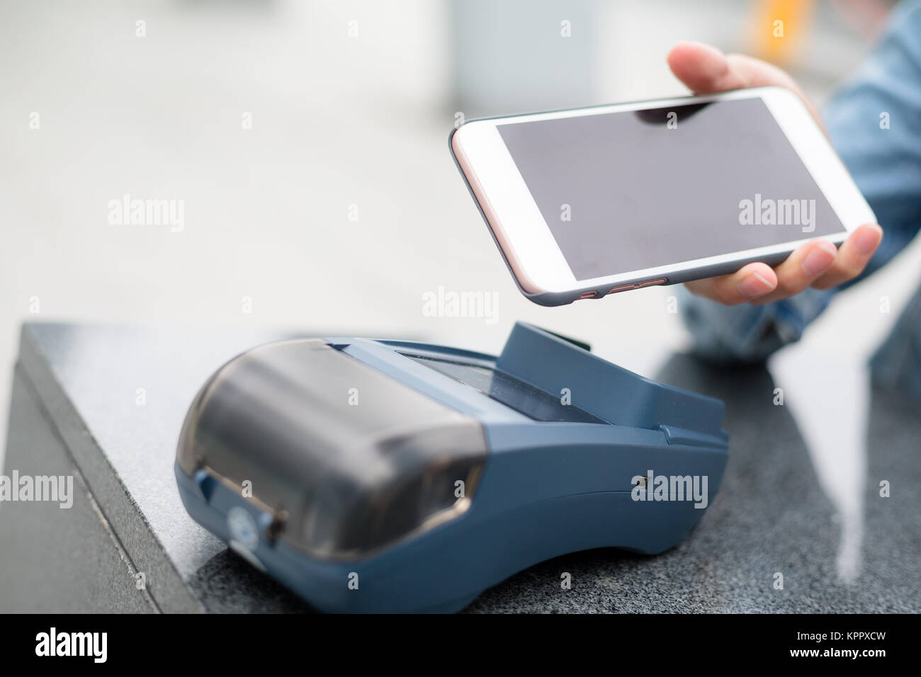 Woman using cellphone for payment Stock Photo - Alamy