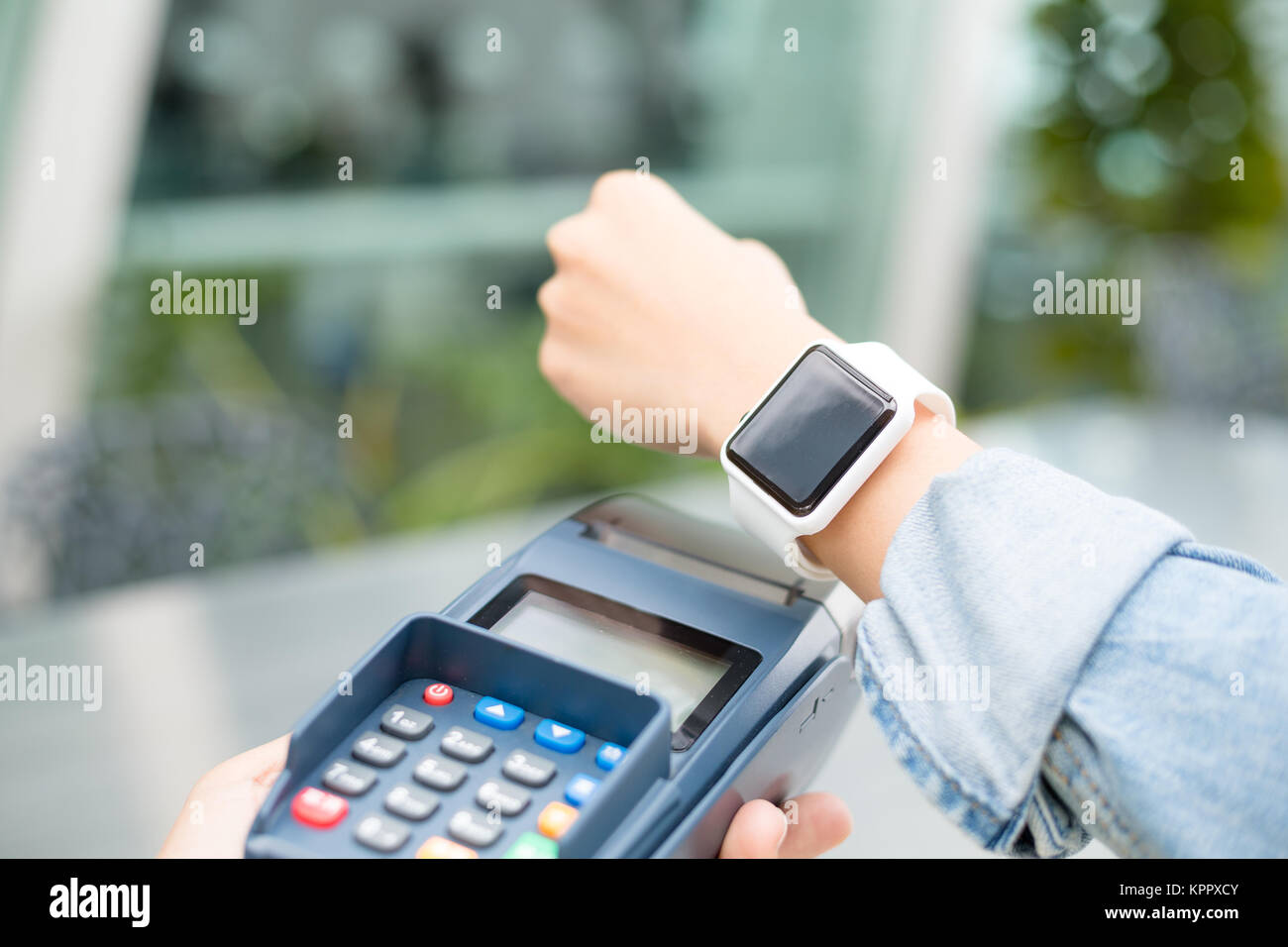 Woman using wearable watch to pay Stock Photo - Alamy