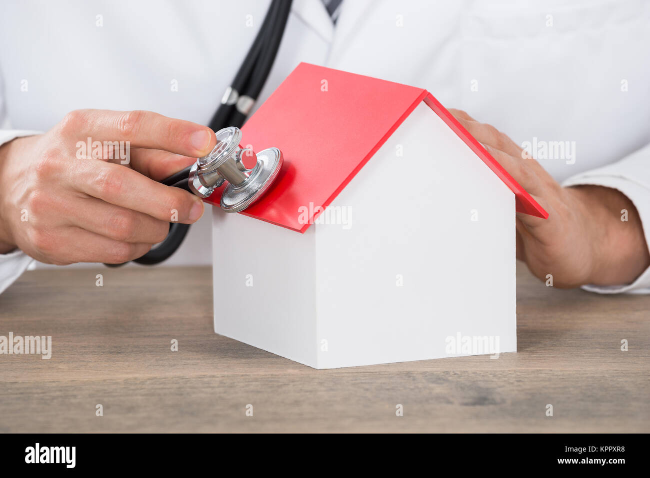 Doctor Hand Holding Stethoscope On House Model Stock Photo - Alamy