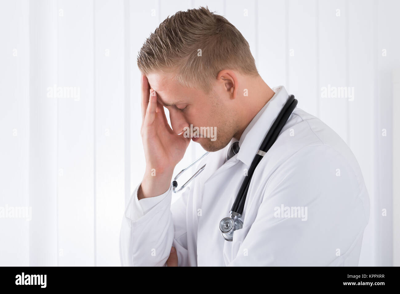 Sad Doctor Standing In Clinic Stock Photo - Alamy