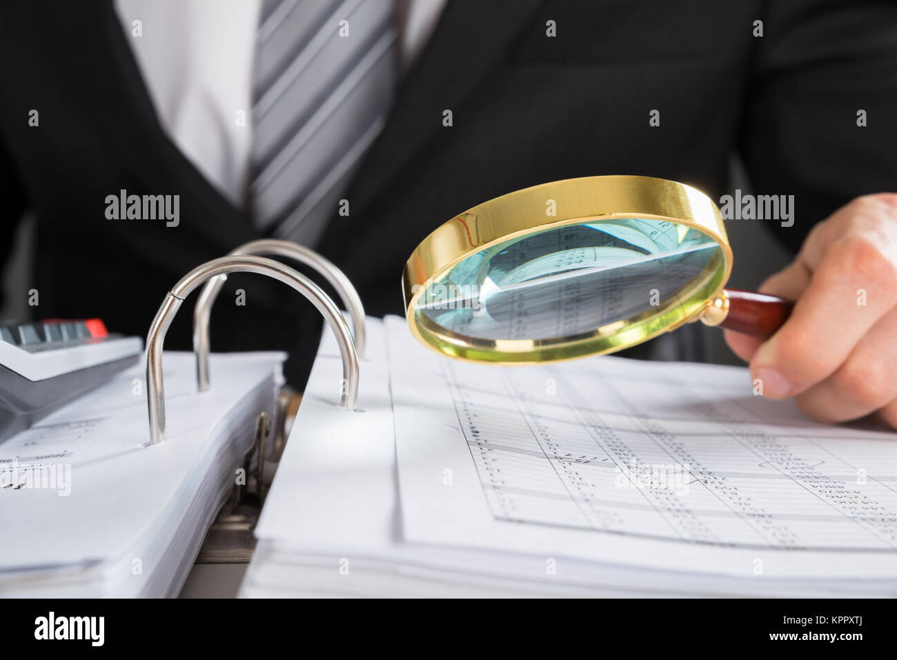 Businessman Examining Invoice With Magnifying Glass Stock Photo - Alamy