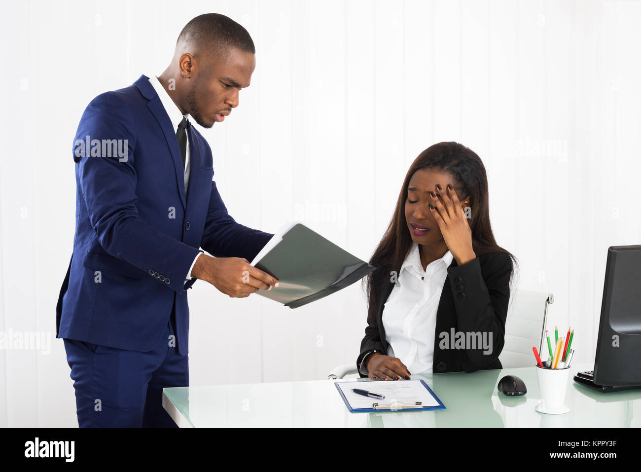 Boss Showing Document To Her Female Executive Stock Photo - Alamy