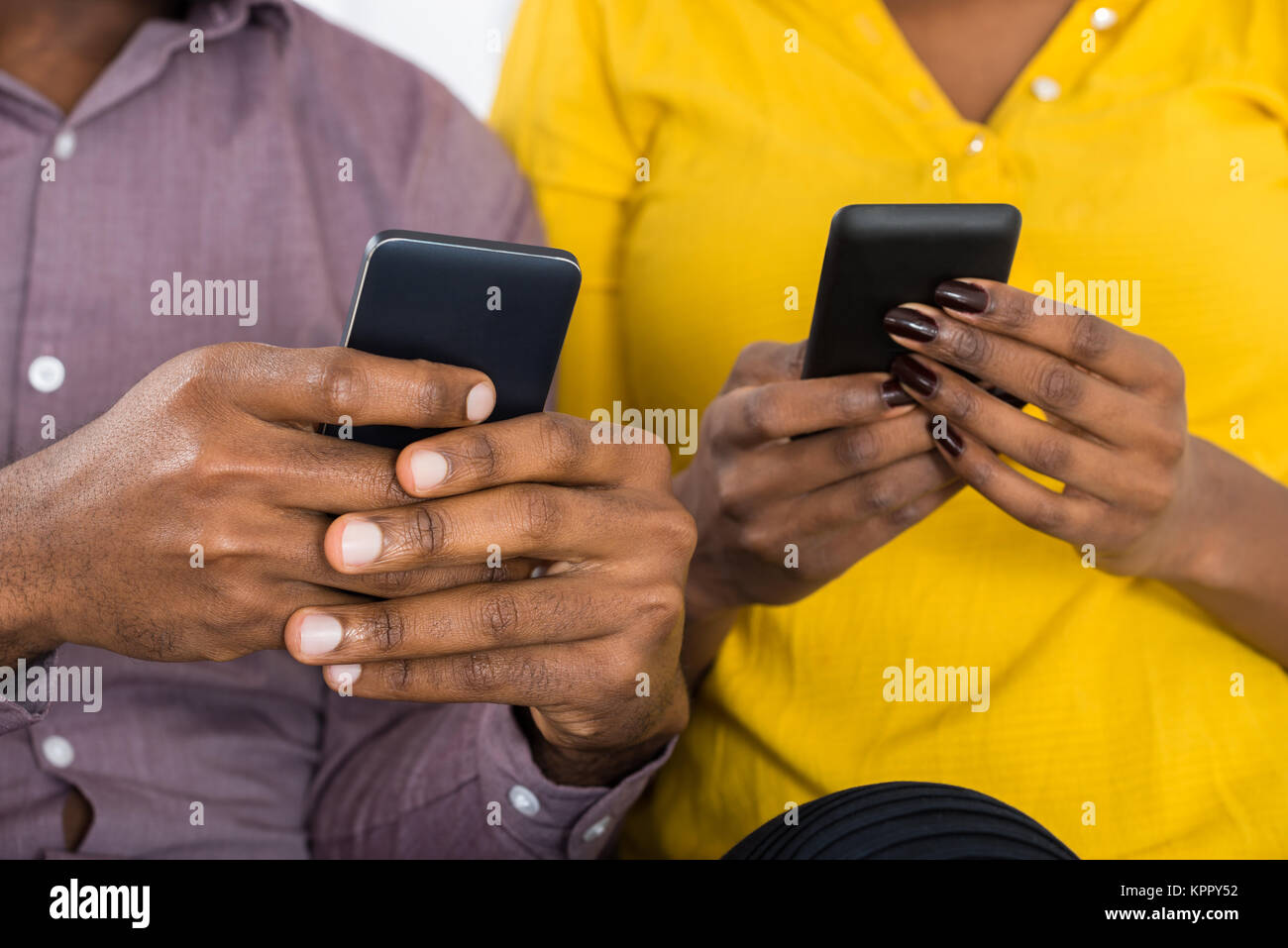 Couple Holding Mobile Phones In Hand Stock Photo - Alamy