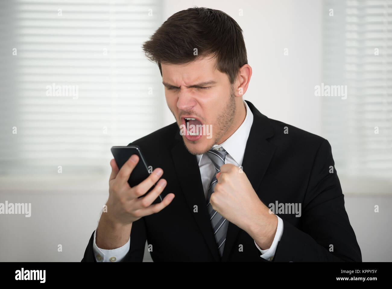 Businessman Screaming On Smart Phone Stock Photo - Alamy