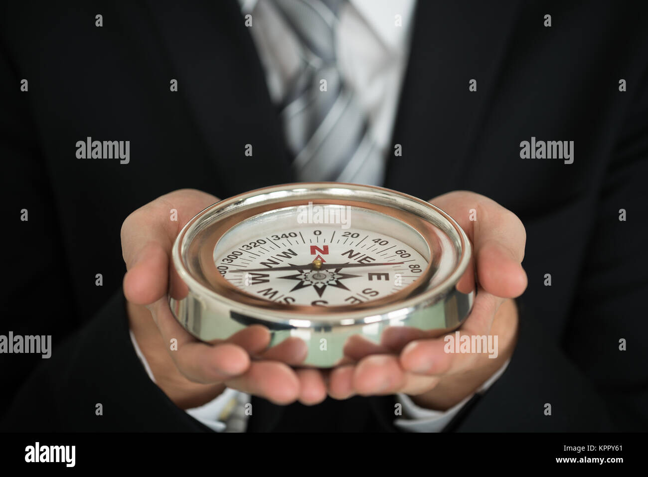 Businessman Hand Holding Compass Stock Photo - Alamy