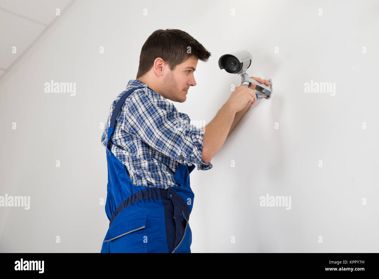 Technician Adjusting CCTV Camera Stock Photo - Alamy