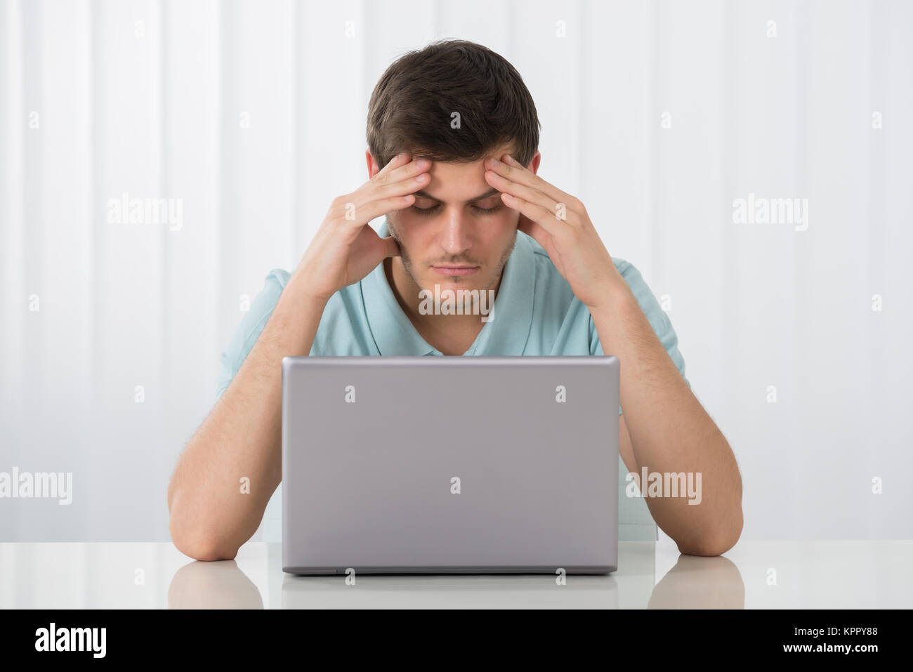Sad Man Working On Laptop Stock Photo - Alamy