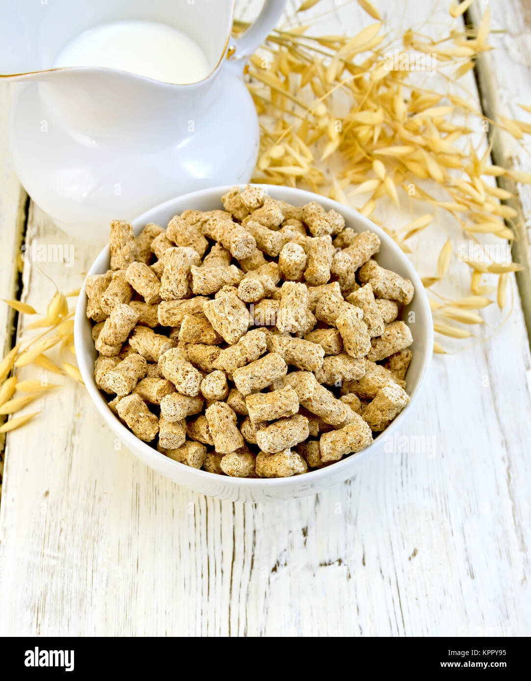 Bran in bowl with milk on board Stock Photo - Alamy