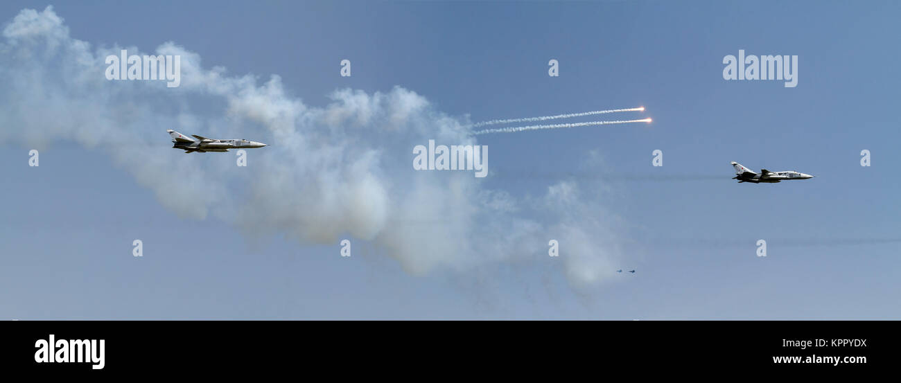 Aircraft fighter flies and shoots heat guns in the blue sky Stock Photo ...