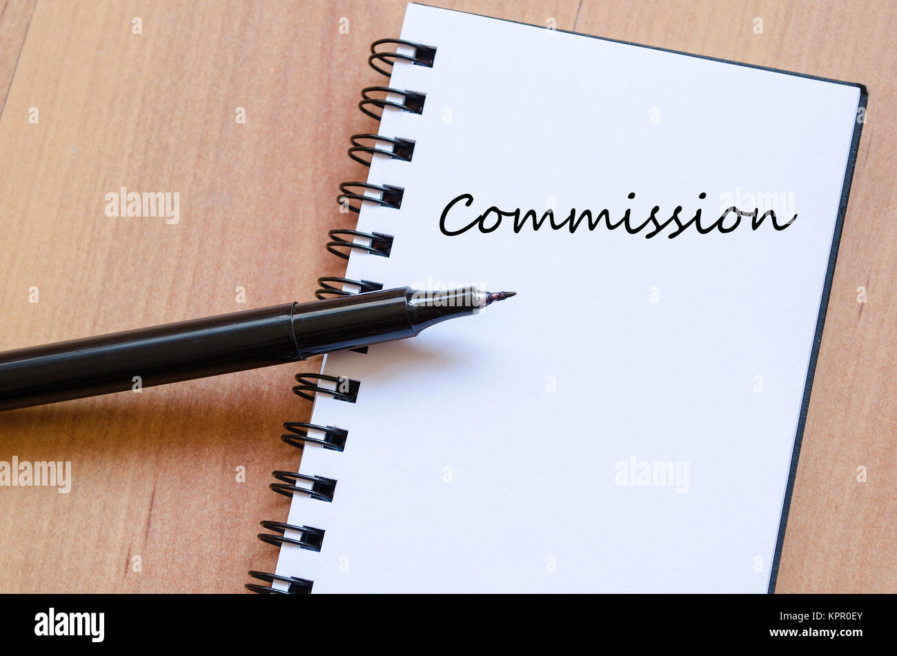 Commission write on notebook Stock Photo - Alamy