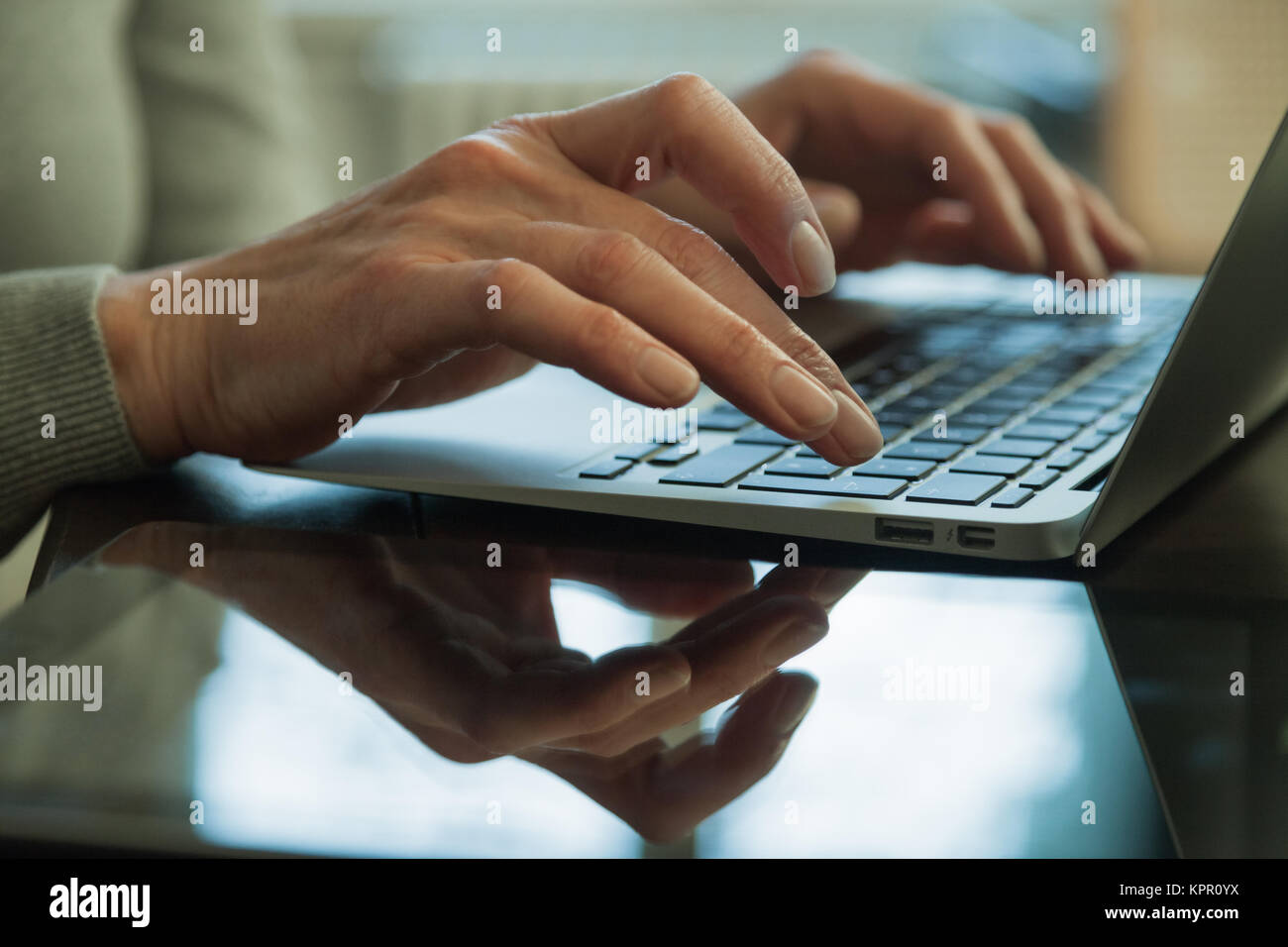 Woman's hands working on a laptop Stock Photo - Alamy