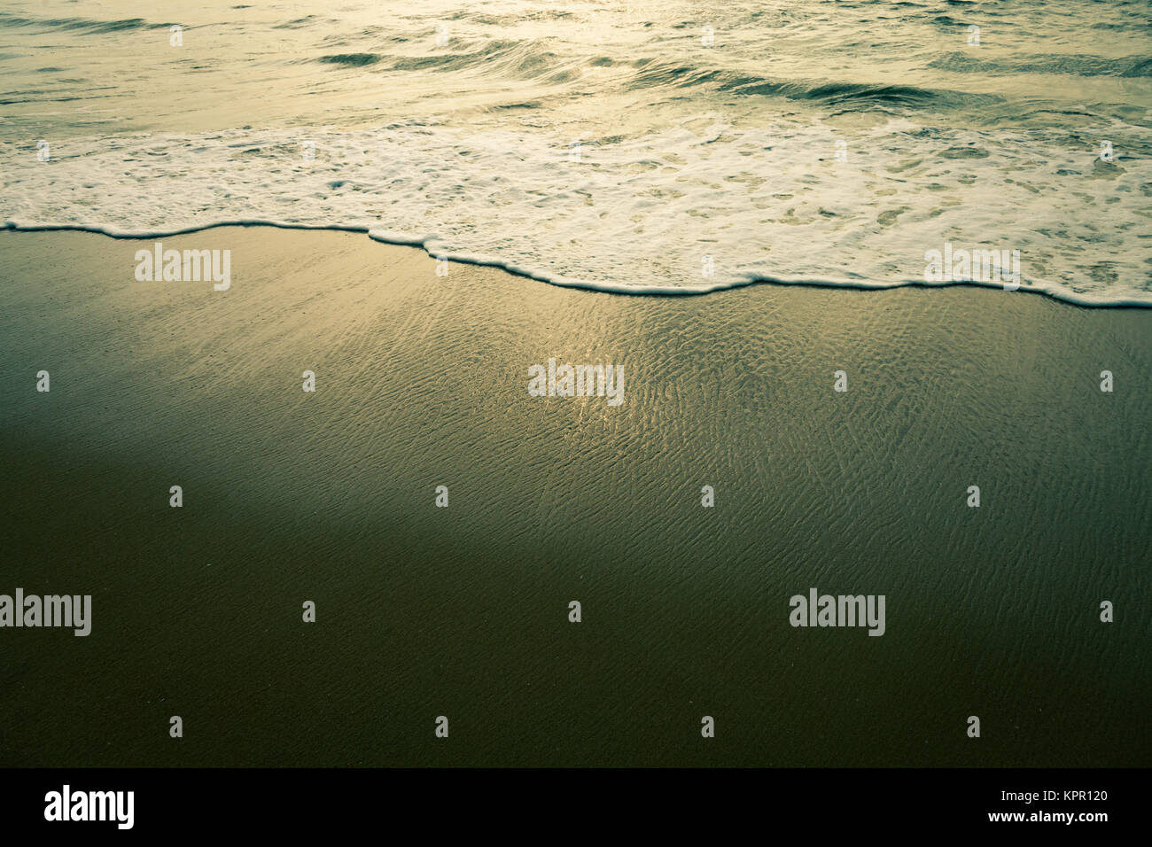 Beautiful water spray at the sandy beach Stock Photo - Alamy