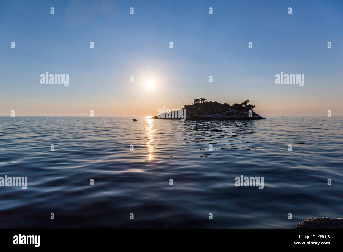 Sea sunset with island Stock Photo - Alamy