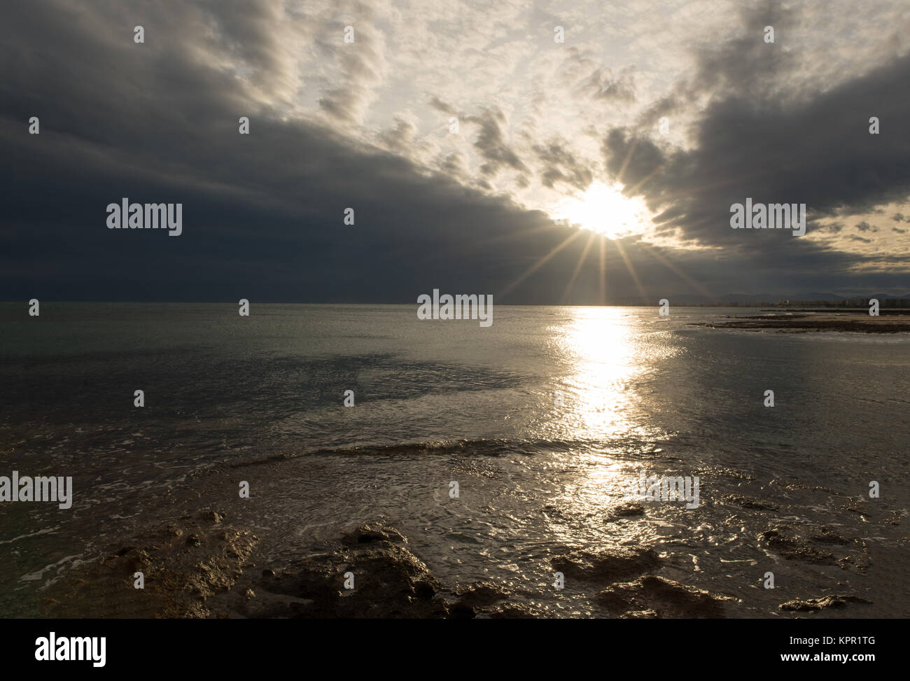 The calm sea in a very cloudy sunset in Spain Stock Photo - Alamy