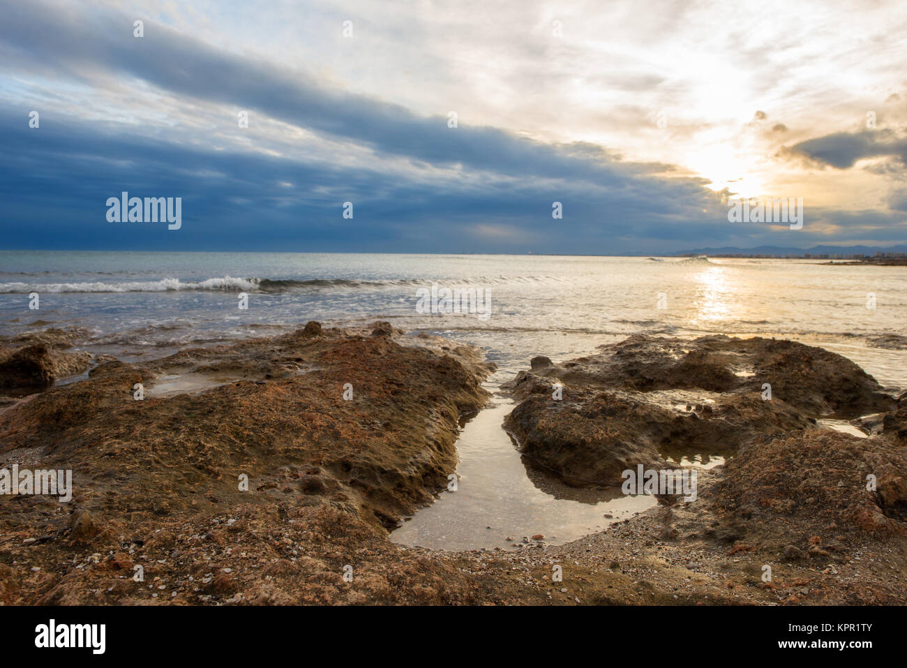 The calm sea in a very cloudy sunset in Spain Stock Photo - Alamy