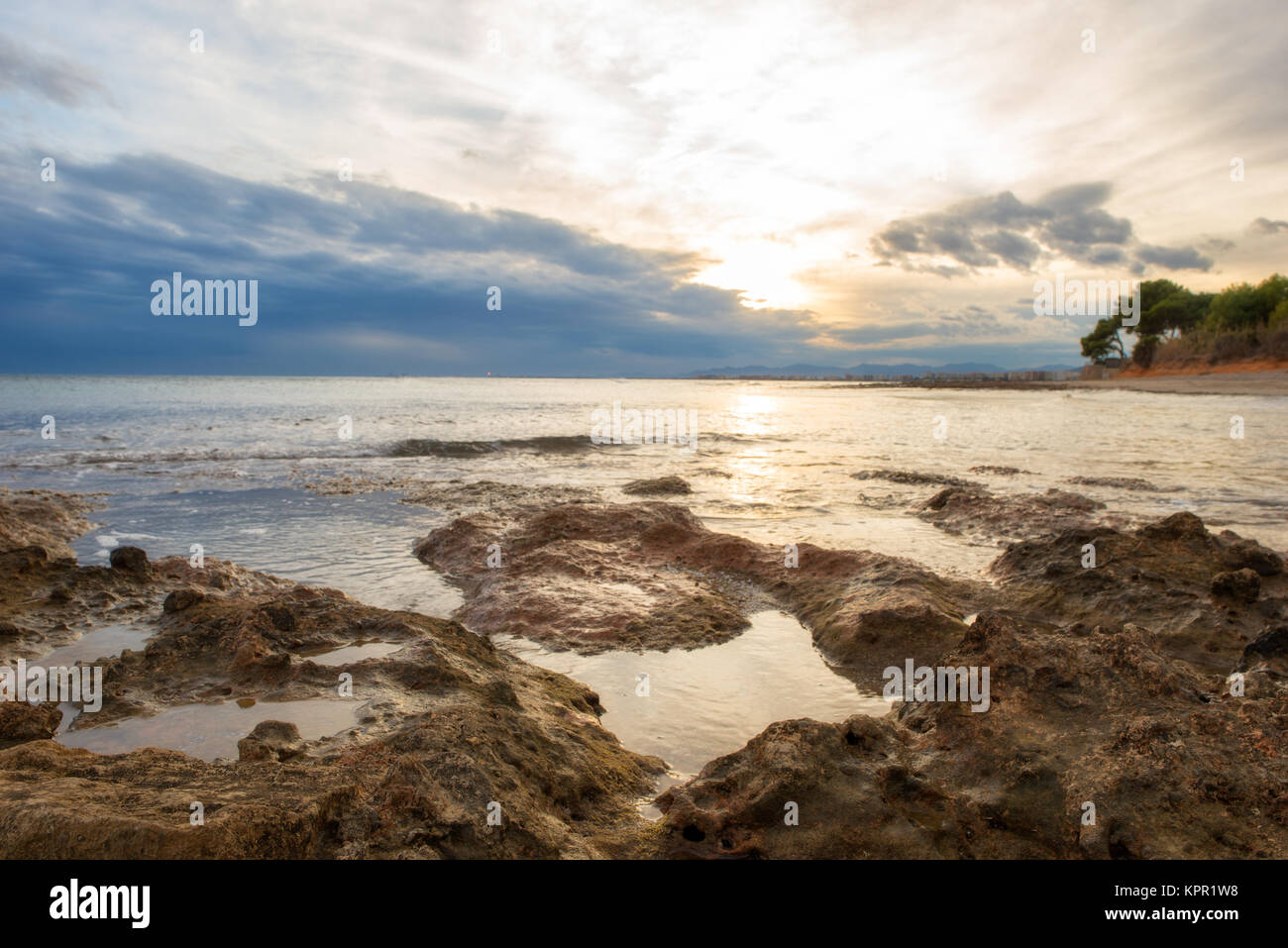The calm sea in a very cloudy sunset in Spain Stock Photo - Alamy