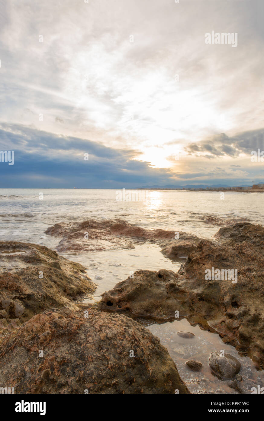 The calm sea in a very cloudy sunset in Spain Stock Photo - Alamy