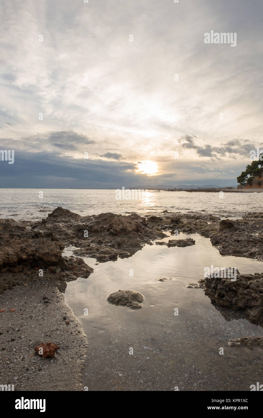 The calm sea in a very cloudy sunset in Spain Stock Photo - Alamy