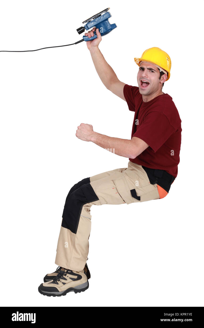 joyful carpenter holding sander machine Stock Photo - Alamy