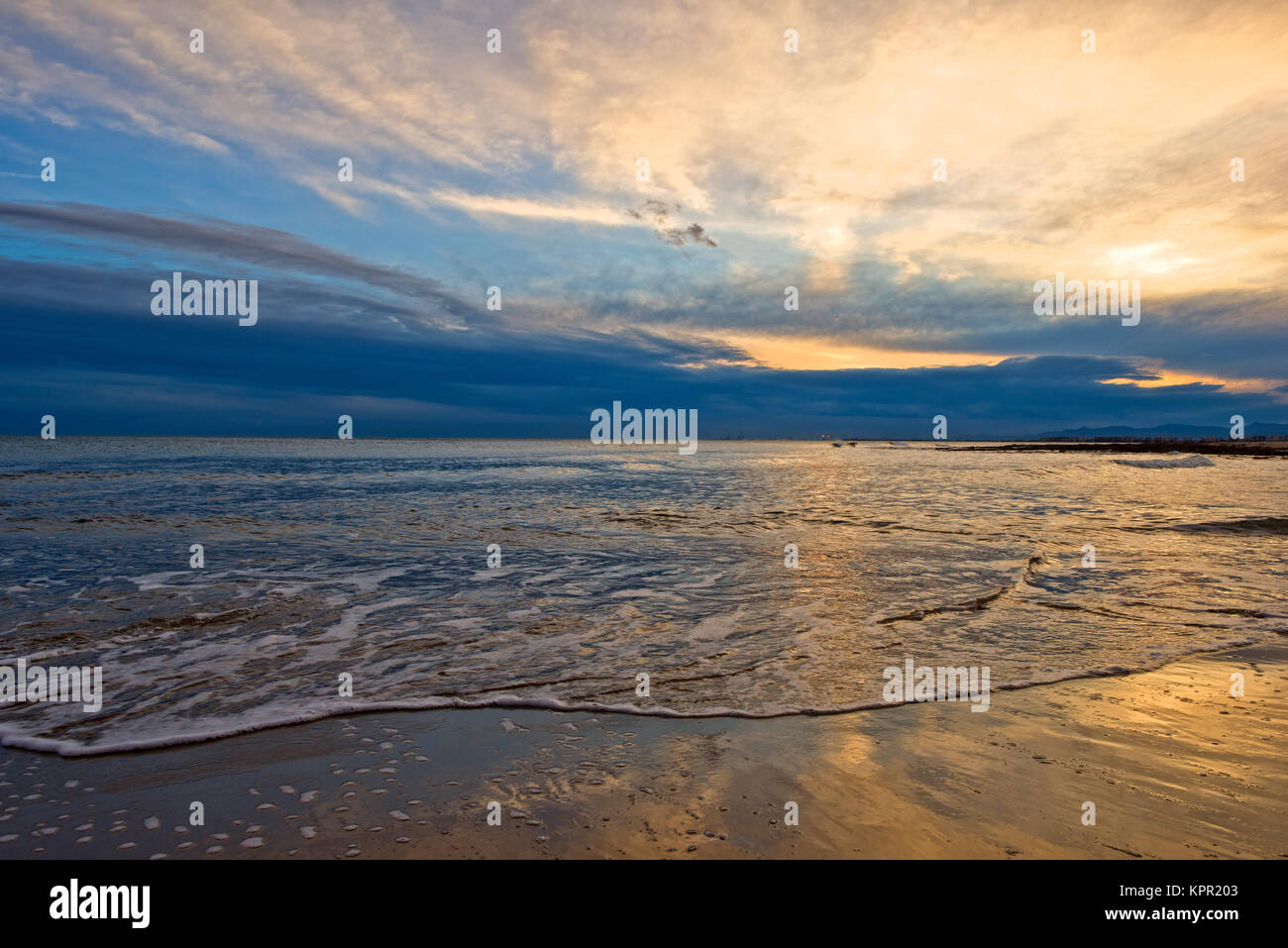 The calm sea in a very cloudy sunset in Spain Stock Photo - Alamy