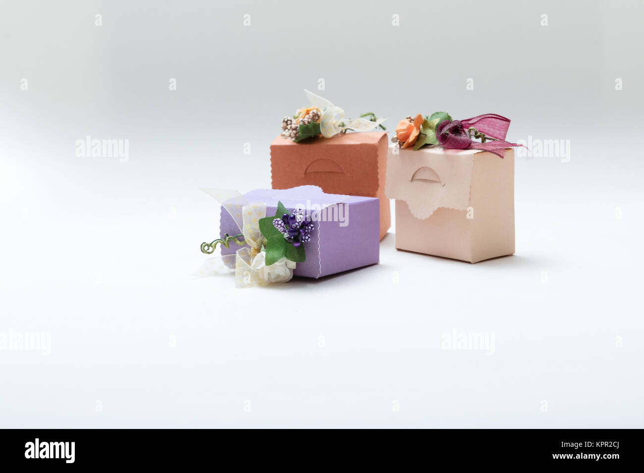 Close up view of special kind gift boxes with ribbon and flowers on ...