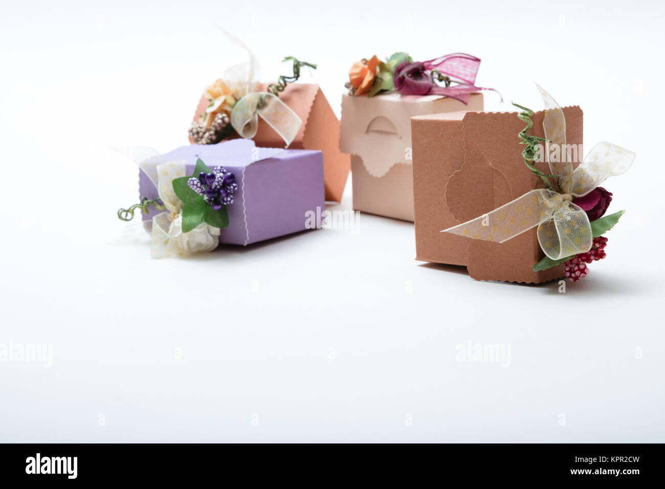 Close up view of special kind gift boxes with ribbon and flowers on ...