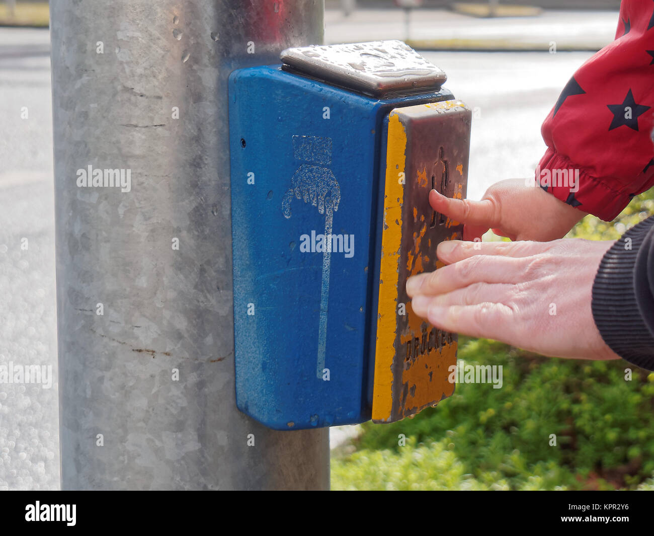 Parent and child pushing a pedestrian light button together Stock Photo ...