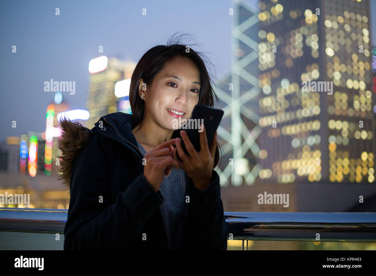 Woman using cellphone at night Stock Photo - Alamy