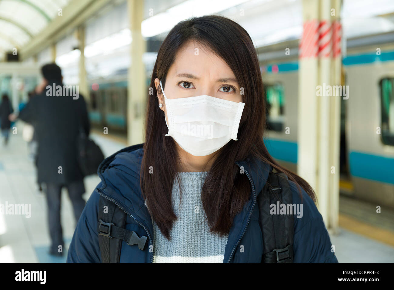 Woman wearing face mask at train platform Stock Photo - Alamy